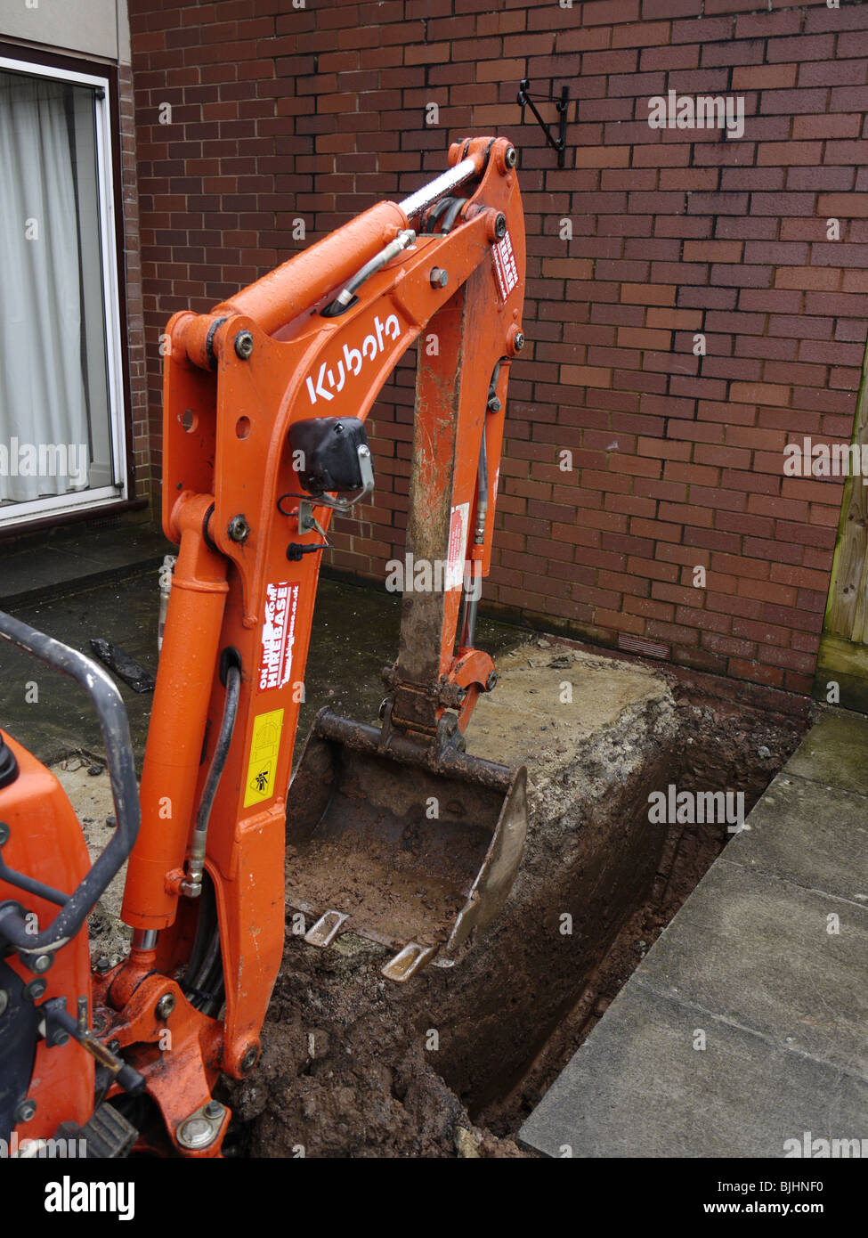 Kubota mini digger digging foundations for extension to semi-detached ...