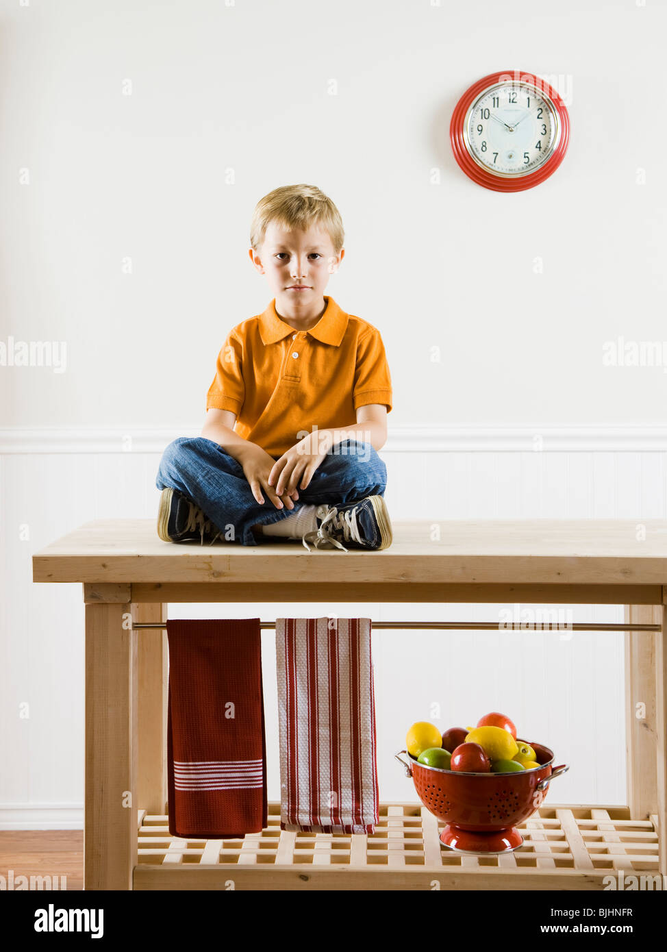boy sitting on a kitchen table Stock Photo - Alamy