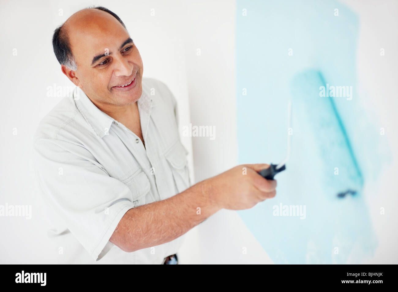 Man painting wall Stock Photo - Alamy