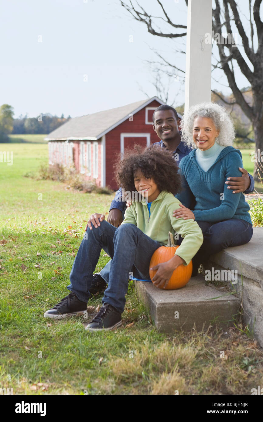 Family sitting on porch Stock Photo - Alamy