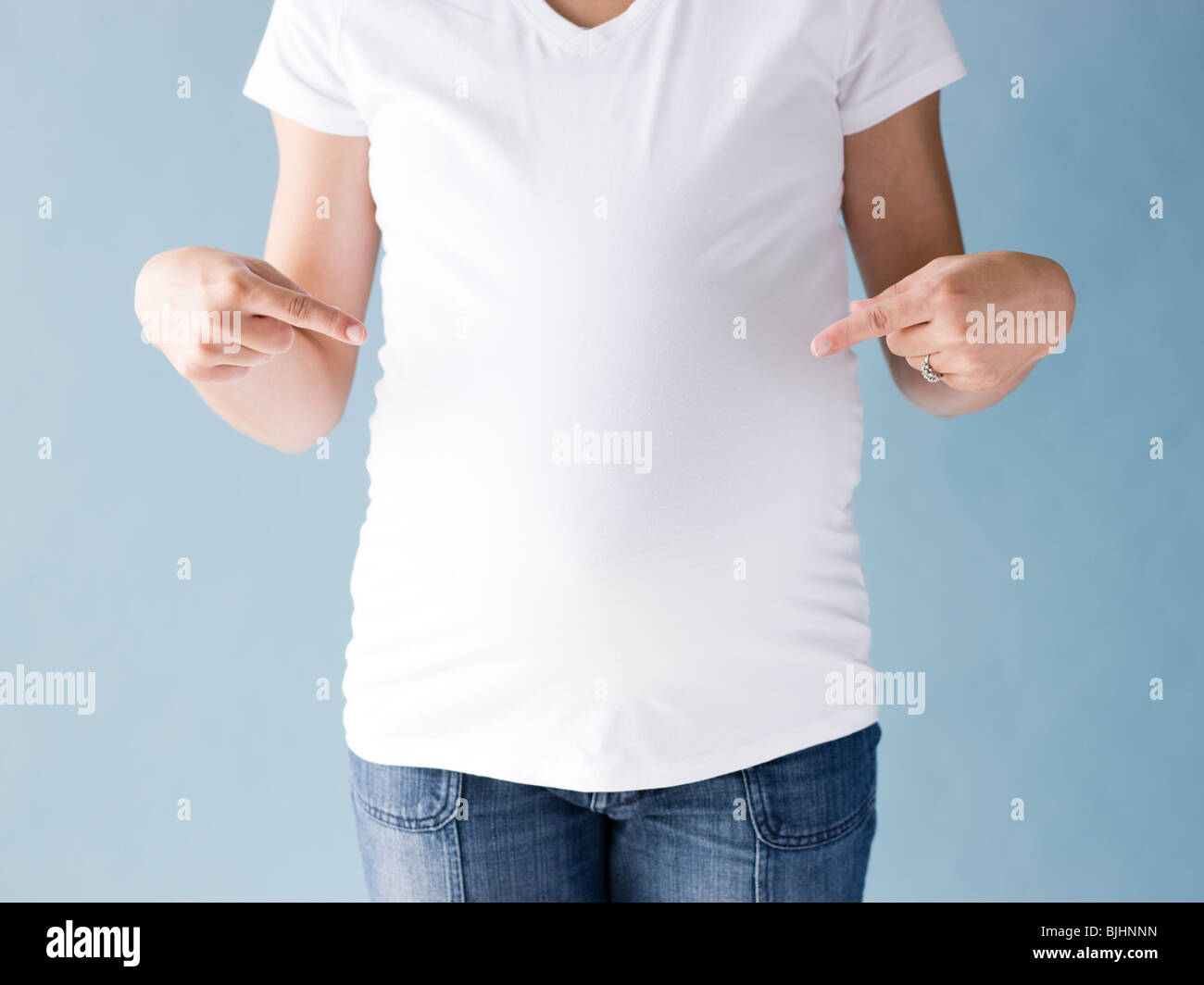 pregnant woman pointing at her stomach Stock Photo - Alamy