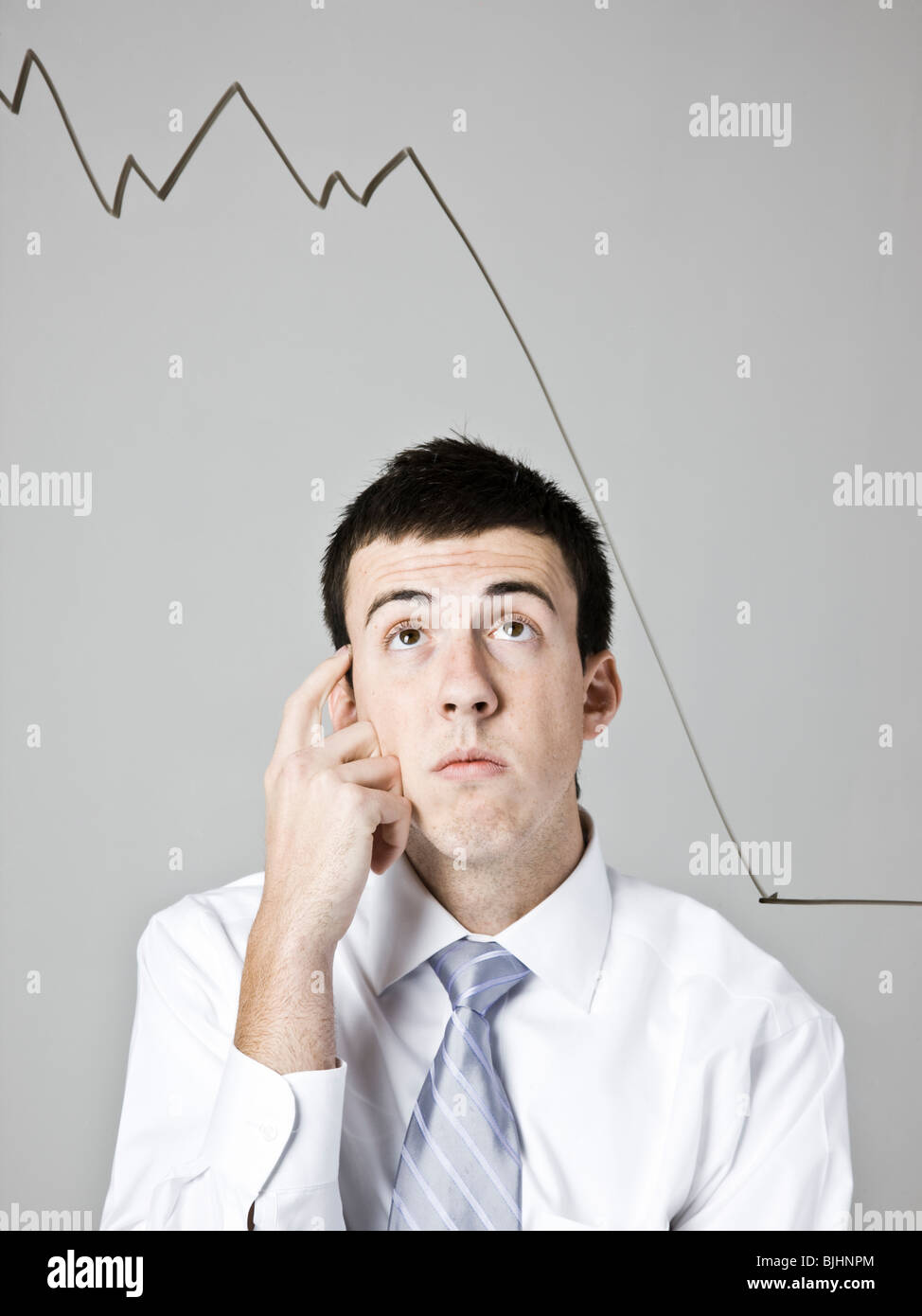 businessman looking at a declining graph Stock Photo - Alamy
