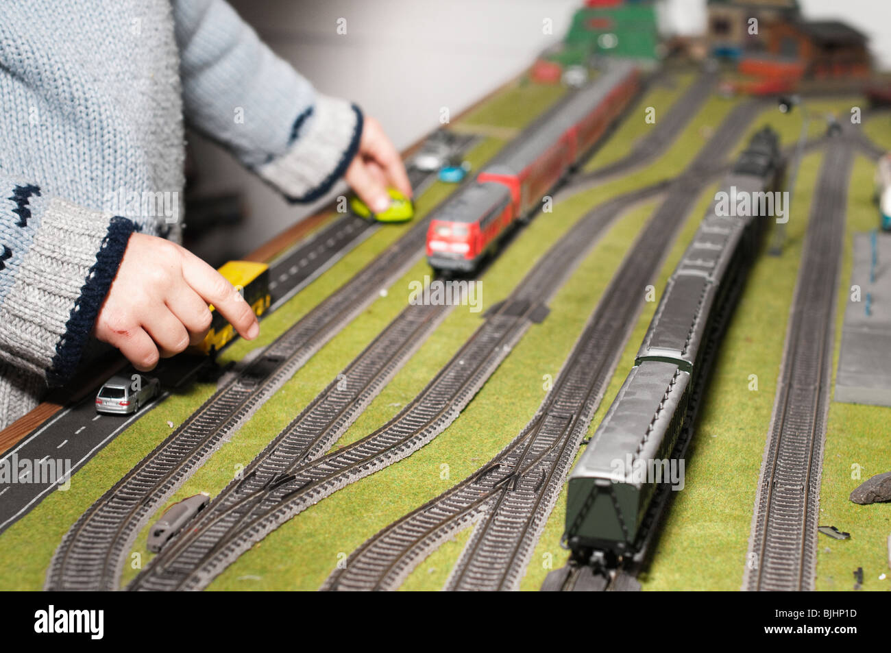 Boy plays with toy railroad-close-up Stock Photo - Alamy