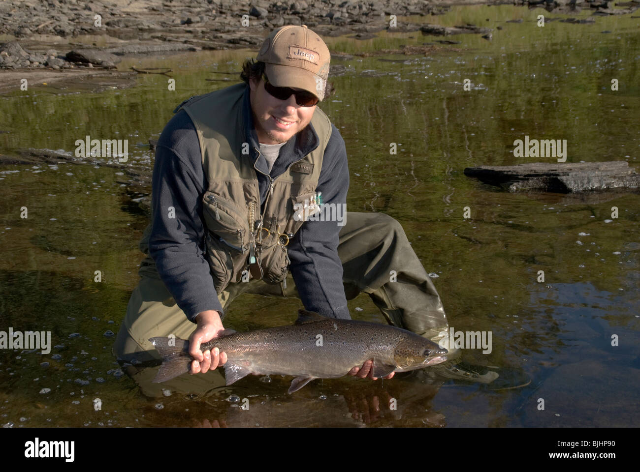 Troy Adams about to release his first Atlantic salmon Stock Photo - Alamy