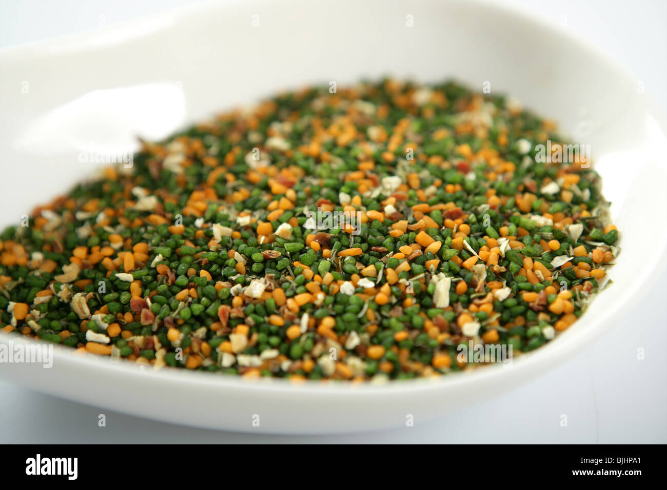 Multicolor vegetables semolina textures in white dish, white background ...