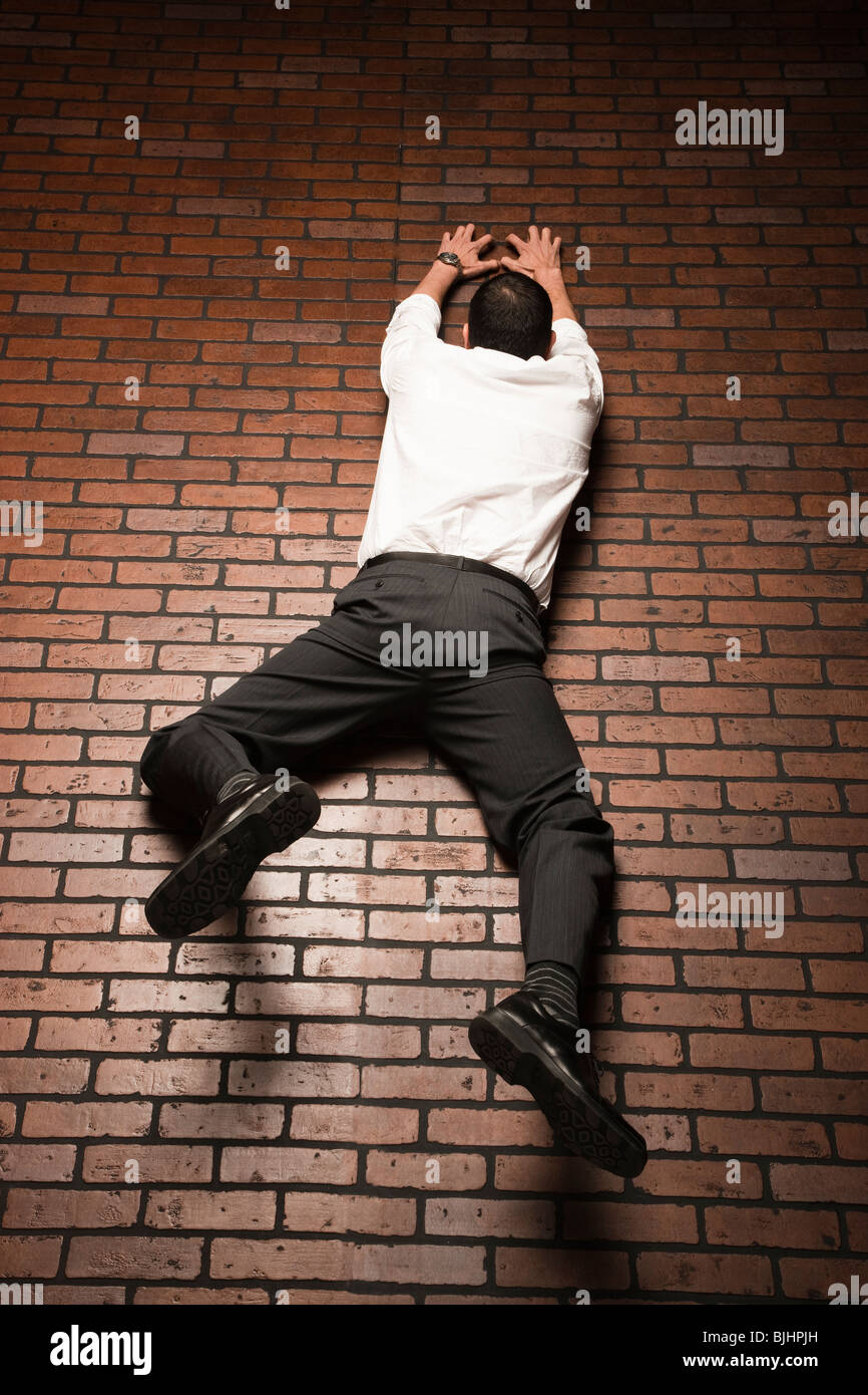 Man bricks falling wall hi-res stock photography and images - Alamy