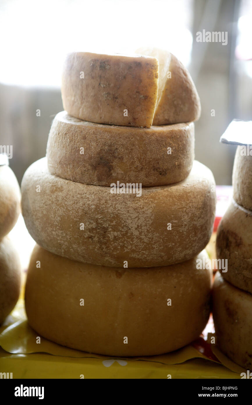 Aged french cheese wheels stacked on the marketplace Stock Photo - Alamy
