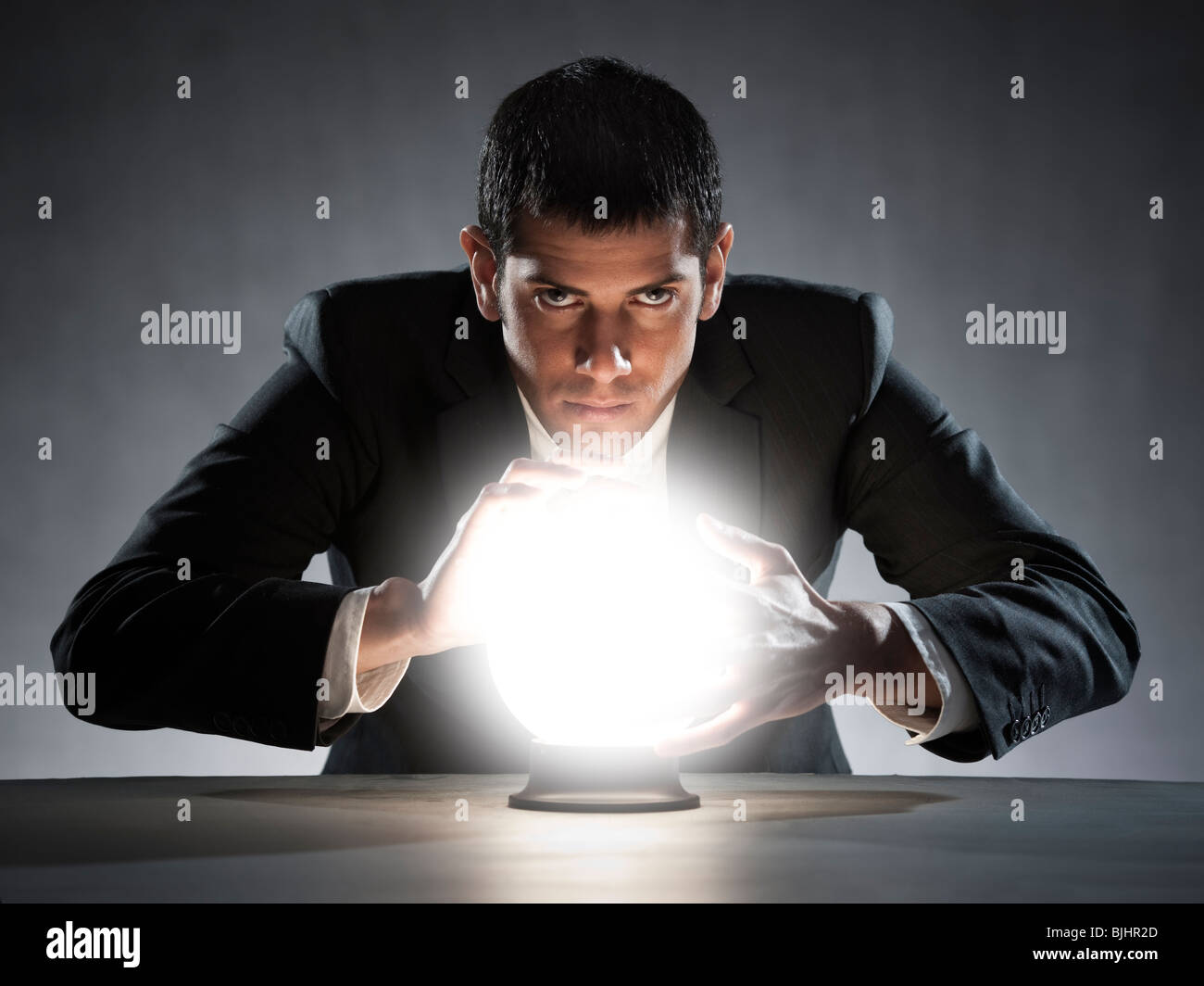 businessman with a glowing crystal ball Stock Photo - Alamy