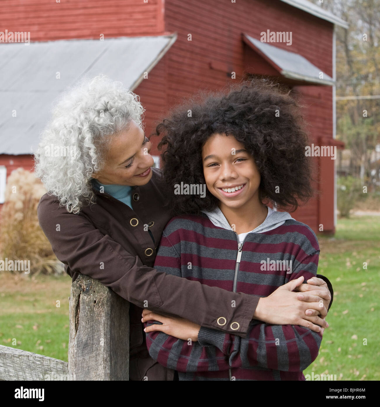 Woman embracing child Stock Photo - Alamy