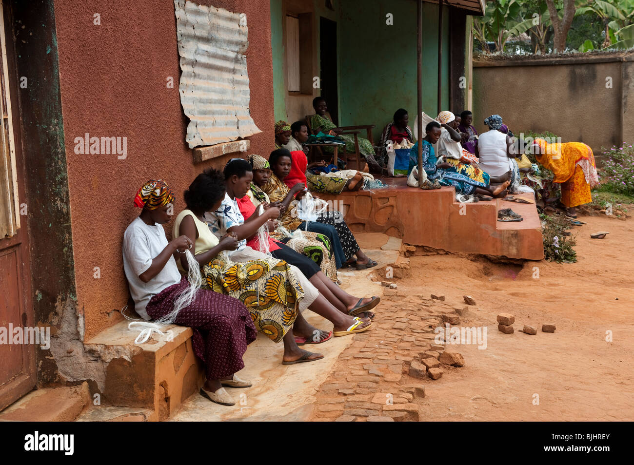 Ladies group working together, weaving produce to sell at local markets ...