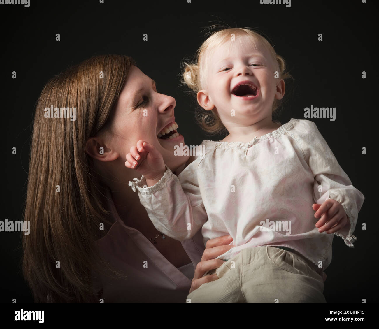 Mother and daughter laughing Stock Photo - Alamy