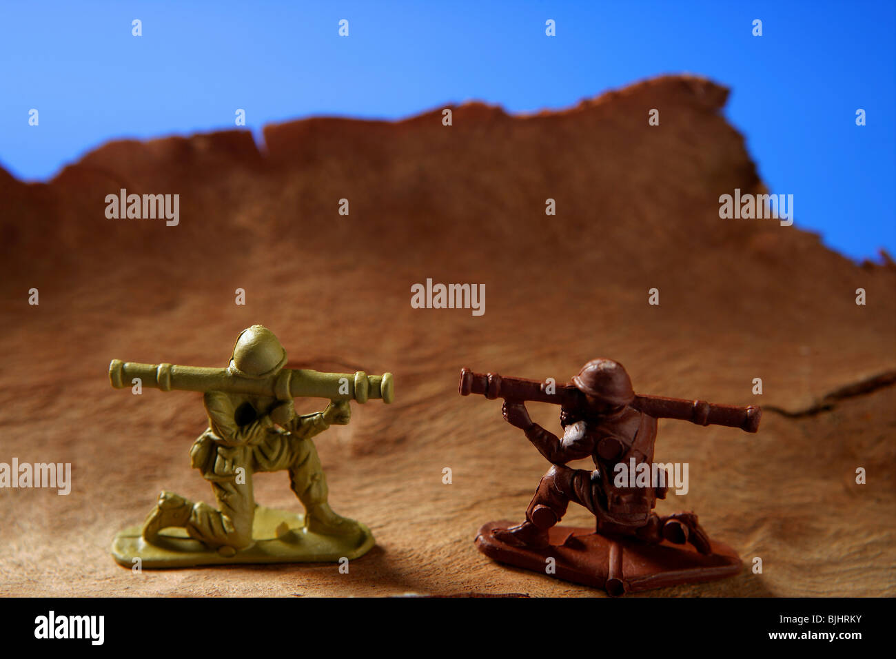 War metaphor, toy little soldiers fighting on wooden mountain Stock ...