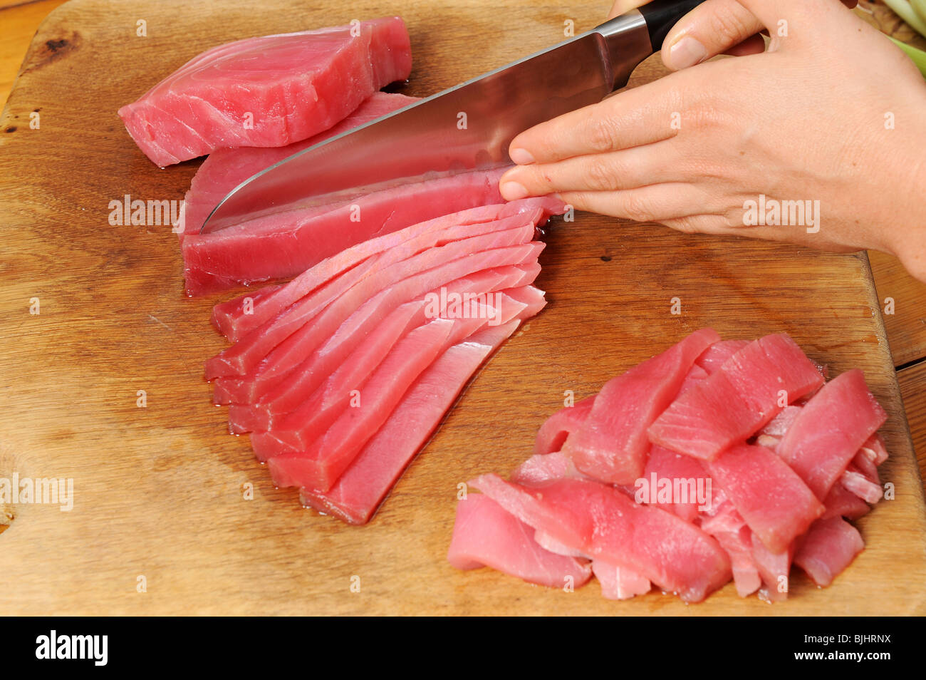tuna fish being sliced and chopped Stock Photo - Alamy