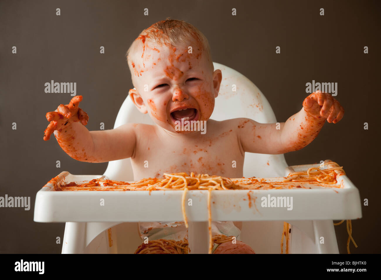 Baby covered in spaghetti Stock Photo - Alamy