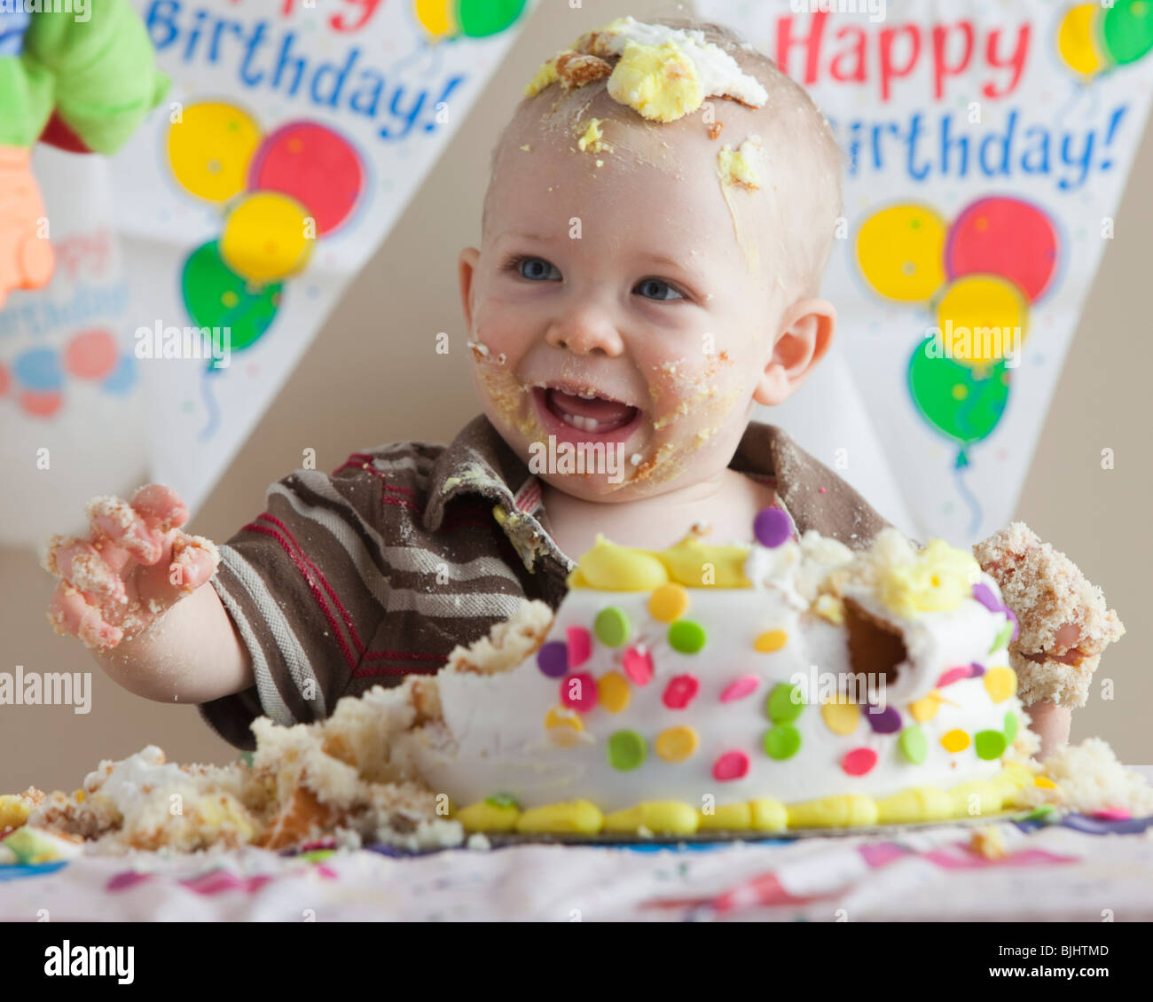Baby covered in birthday cake Stock Photo - Alamy