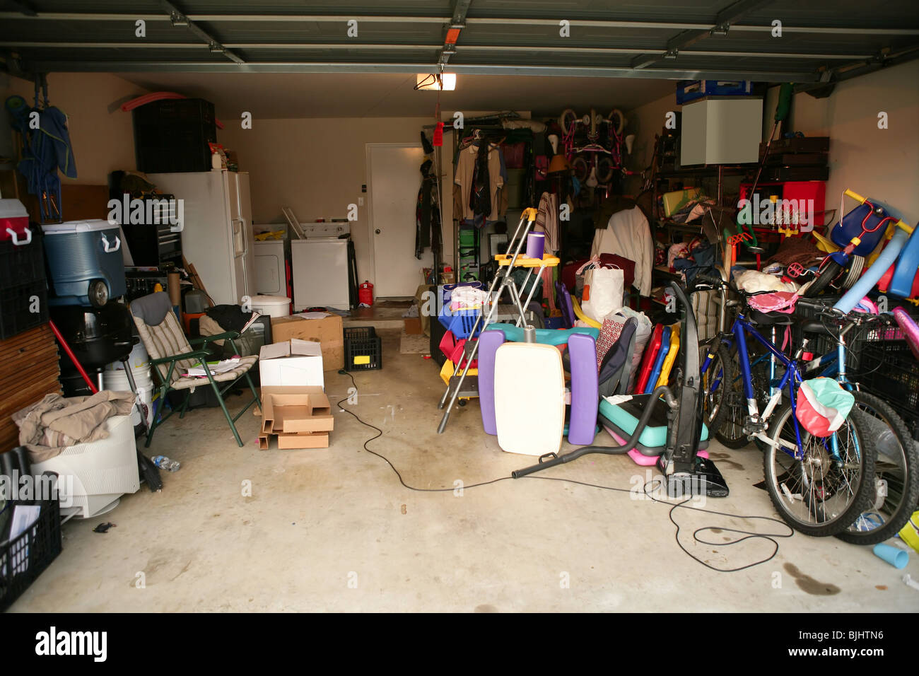 messy abandoned garage full of stuff, chaos at home Stock Photo - Alamy