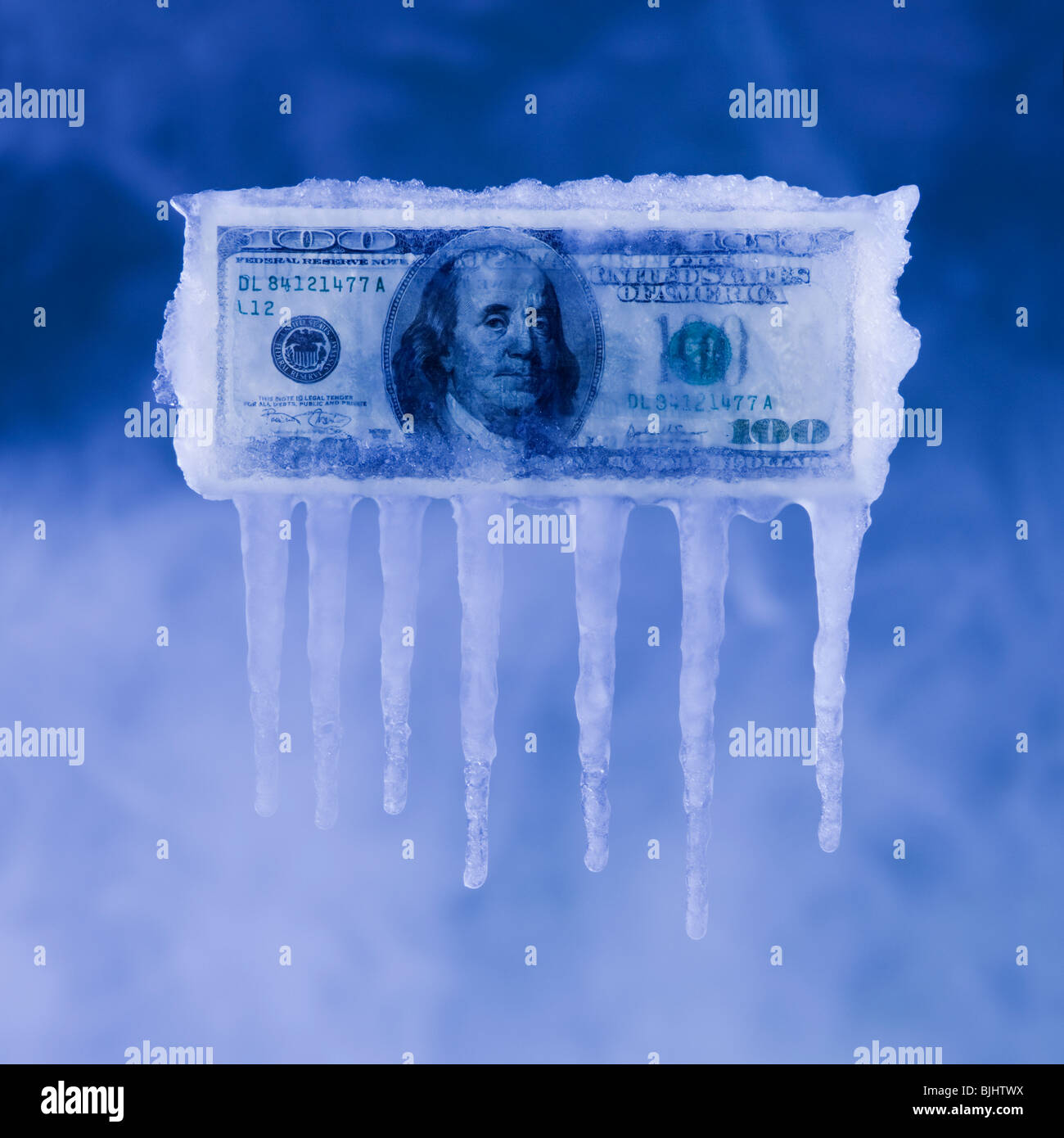 Money covered in ice Stock Photo - Alamy