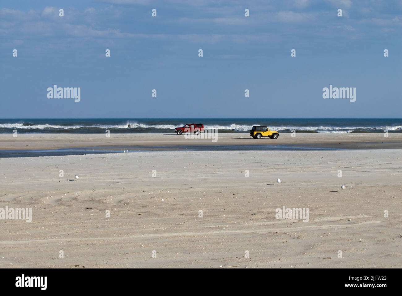 Two four-wheel drive vehicles on public beach Stock Photo - Alamy