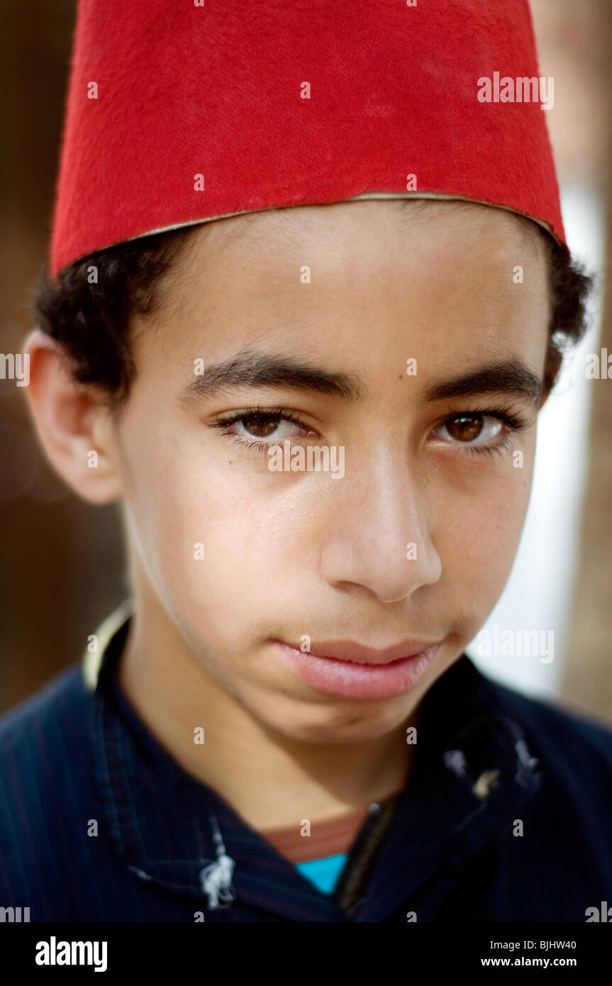 A portrait of an Arab Egyptian boy working at a restaurant and wearing ...