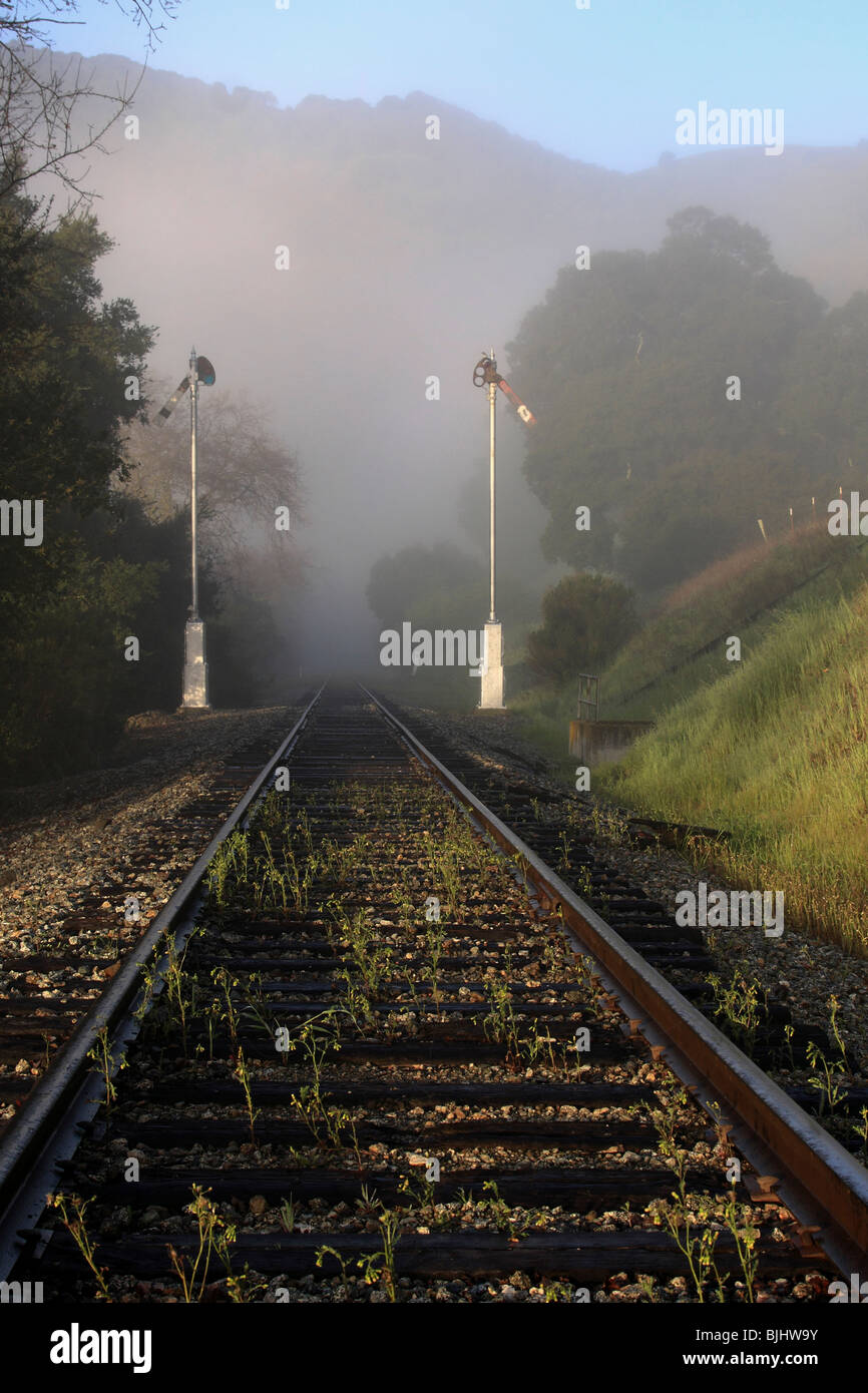 Railroad tracks and signal semaphores in the fog near Sunol, California ...