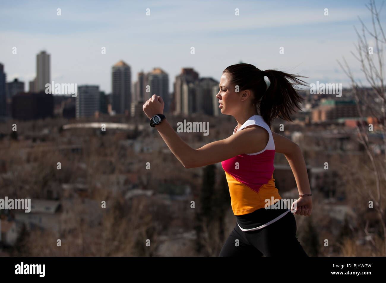 Fit young woman running with Calgary city skyline in background Stock ...
