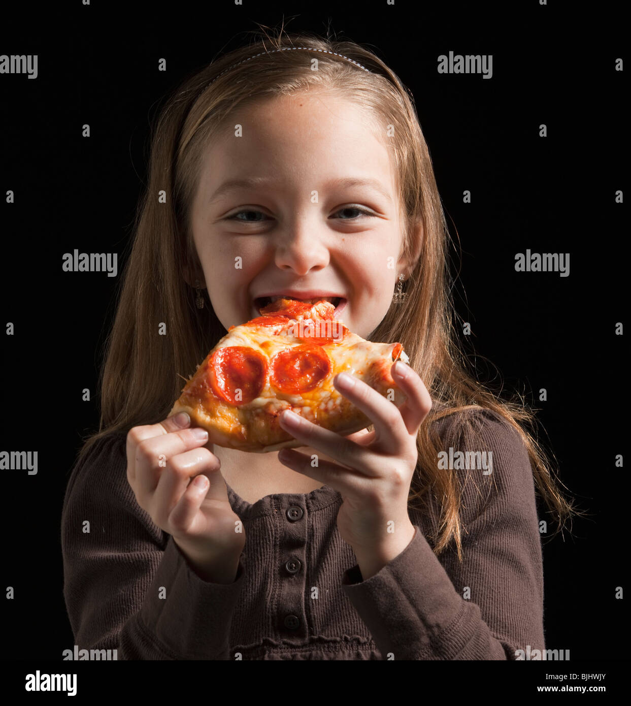 Young girl eating pizza Stock Photo - Alamy