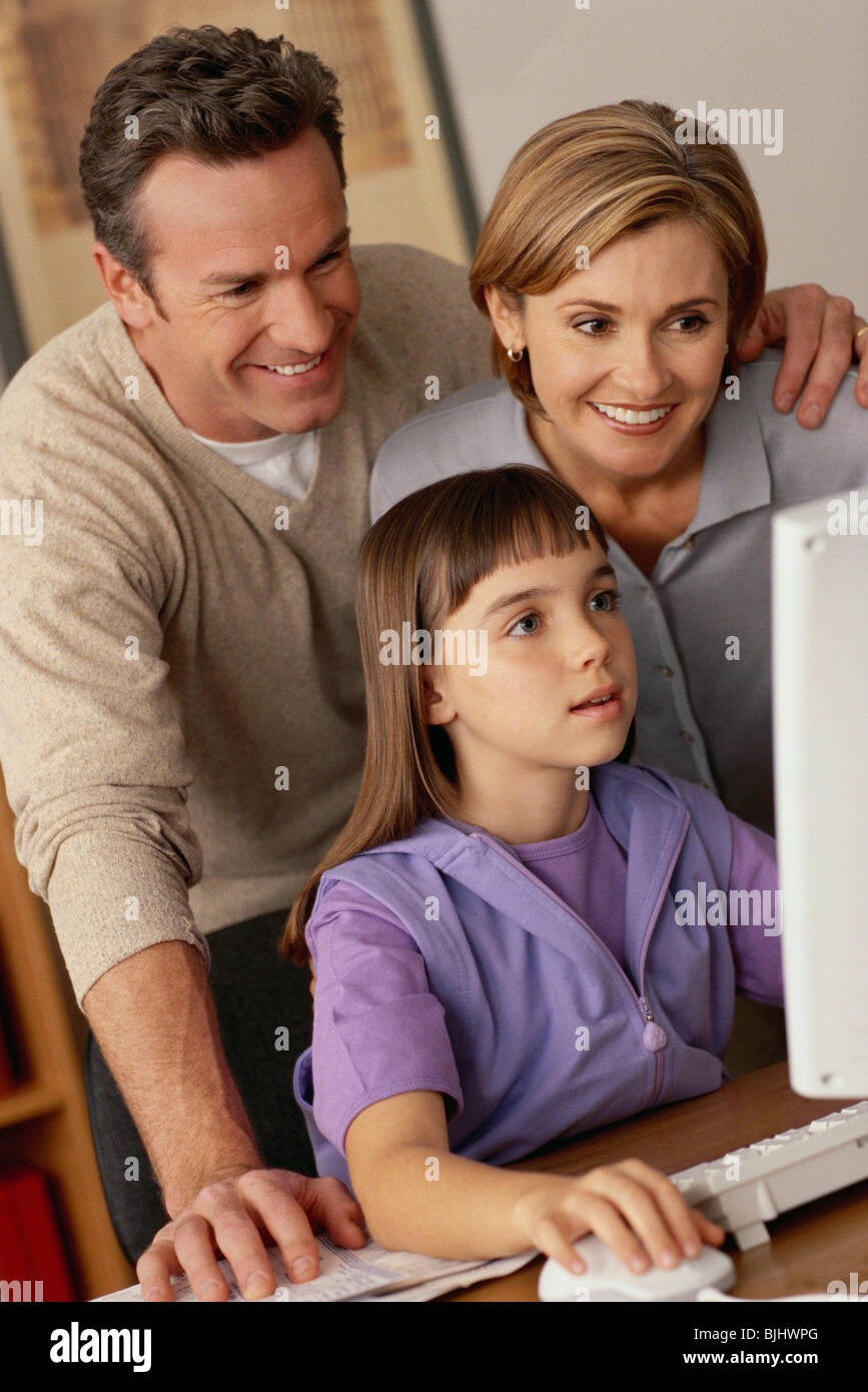 Family looking at computer Stock Photo - Alamy