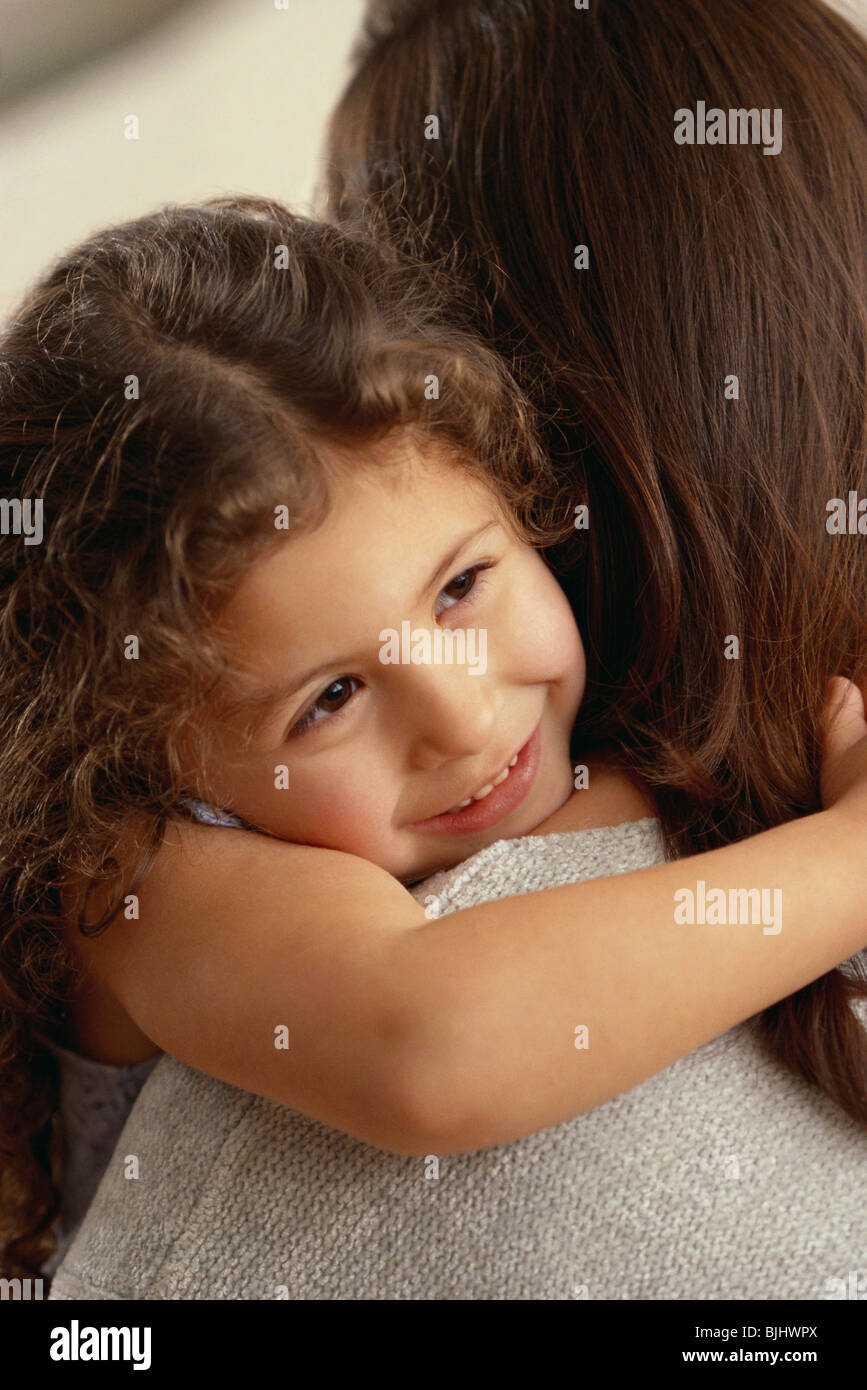 Child embracing mother Stock Photo - Alamy