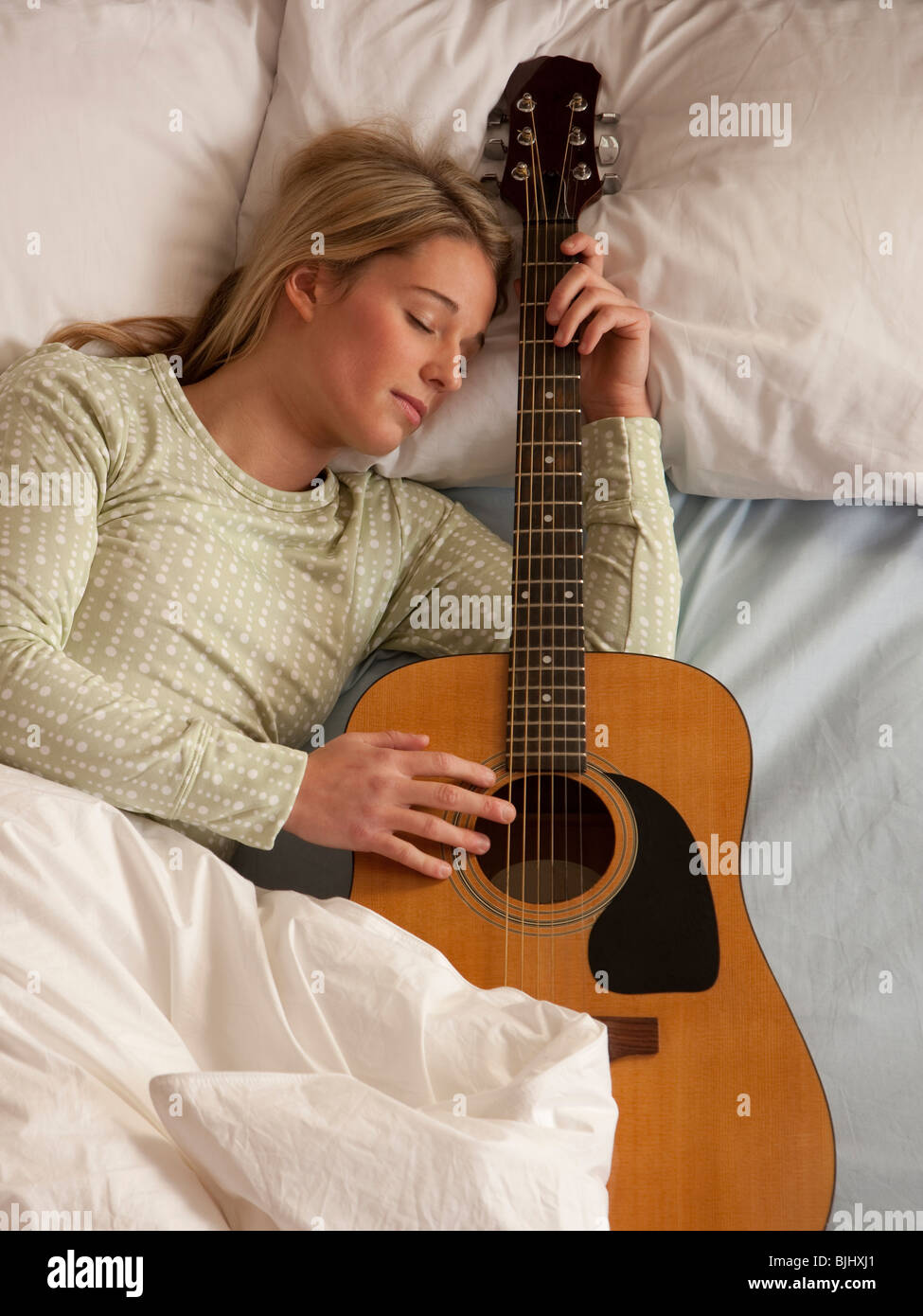 woman sleeping with her guitar Stock Photo - Alamy
