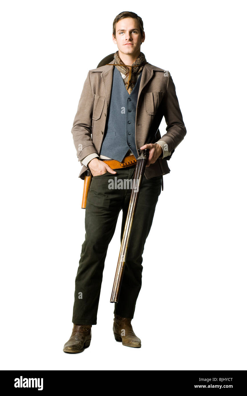 cowboy holding a shotgun Stock Photo - Alamy