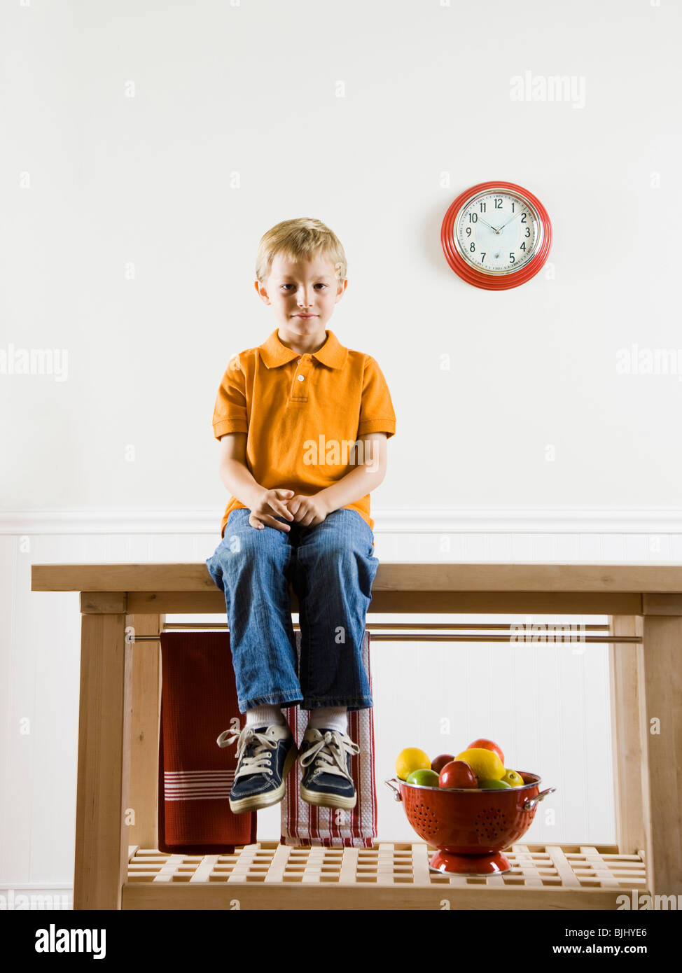 boy sitting on a kitchen table Stock Photo - Alamy