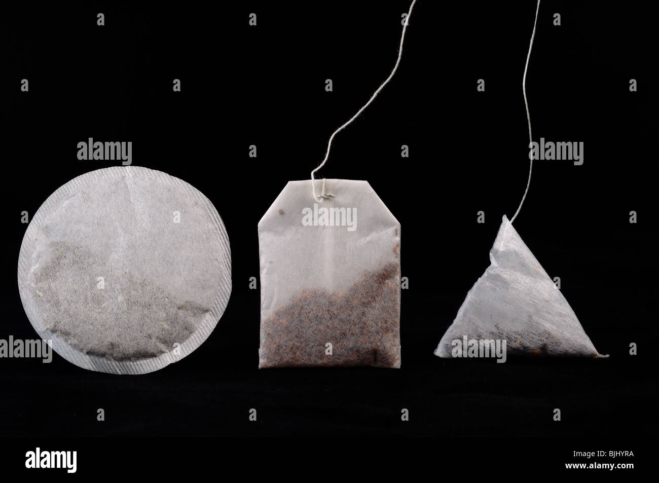 Different shapes of tea bags on black background Stock Photo - Alamy