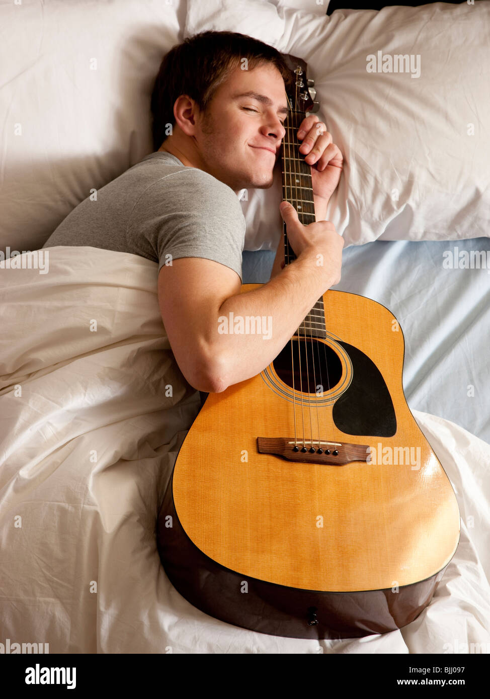 man sleeping with his guitar Stock Photo - Alamy