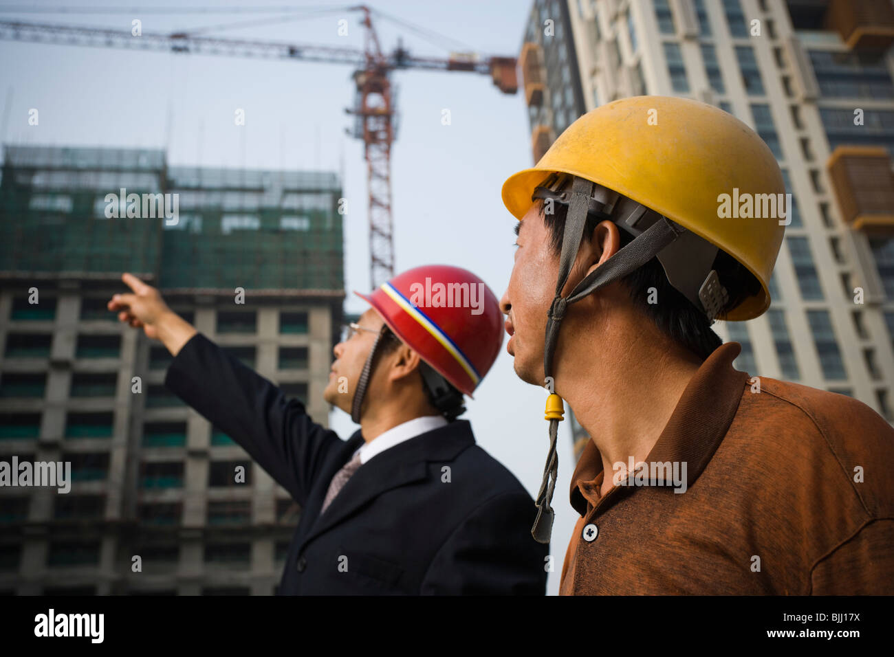 Men on a construction site in China Stock Photo - Alamy