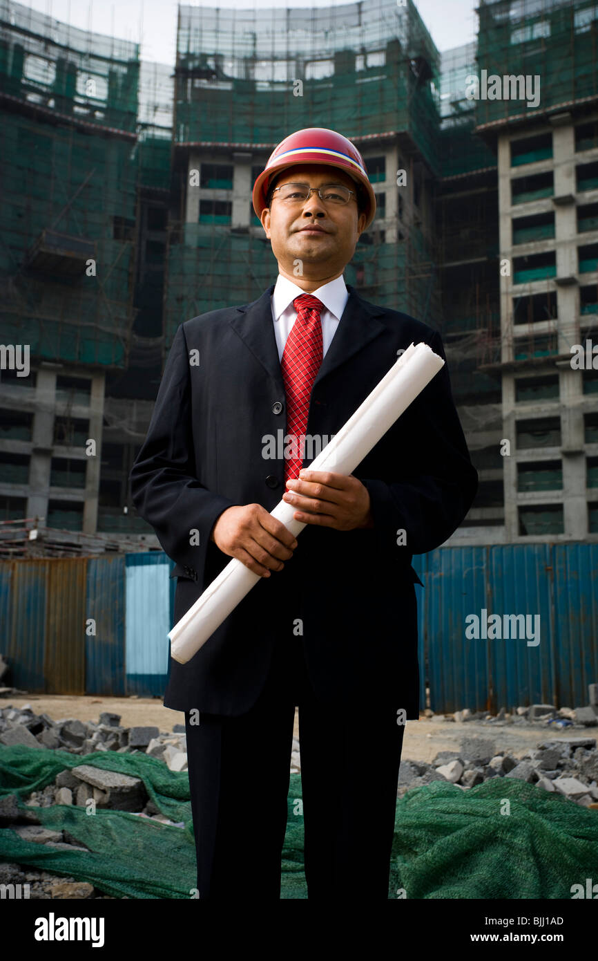 Construction site foreman with blueprints outdoors Stock Photo - Alamy