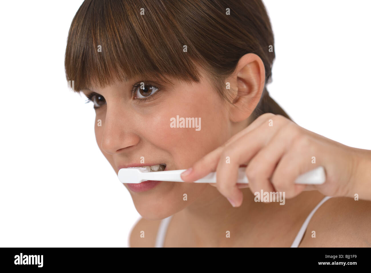 Body care - Female teenager brushing teeth with white toothbrush Stock ...
