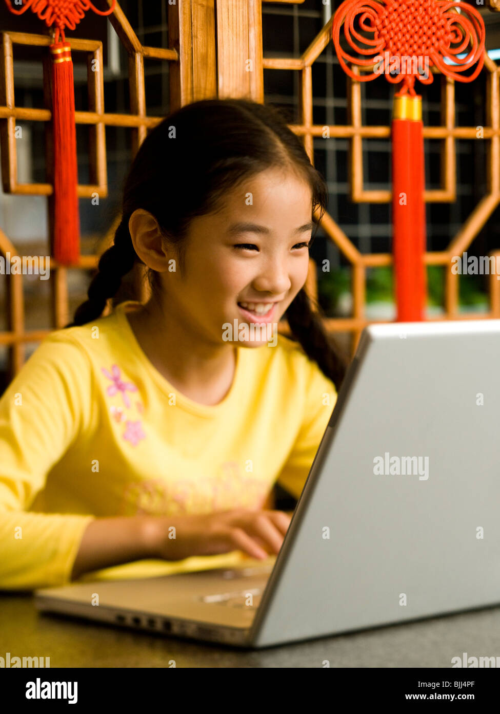 Girl sitting with laptop smiling Stock Photo - Alamy