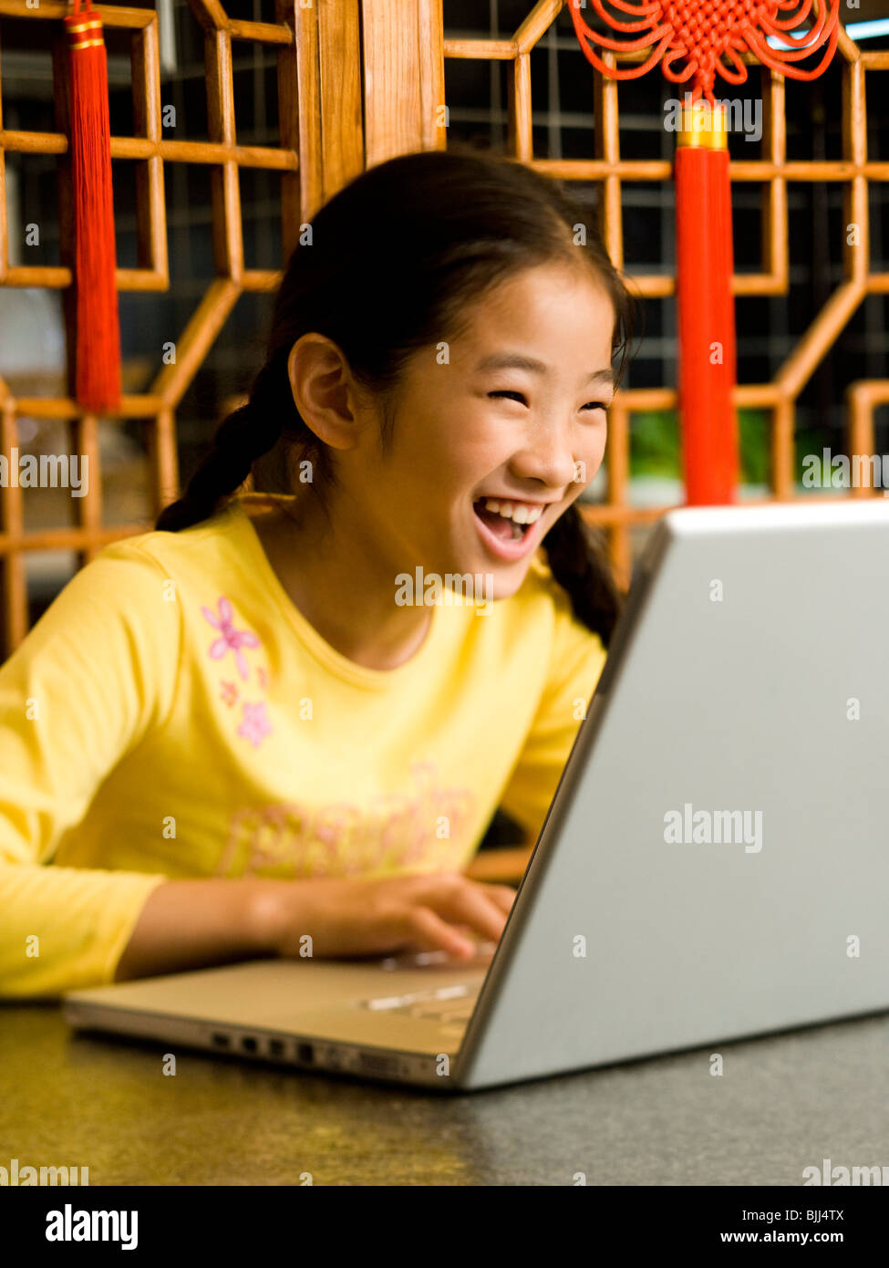 Girl sitting with laptop smiling Stock Photo - Alamy