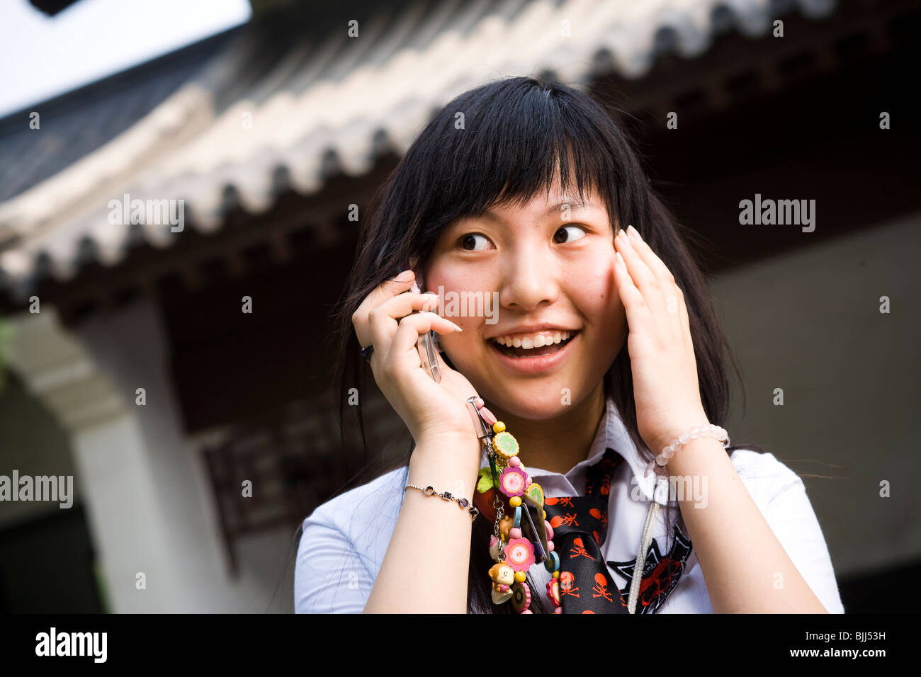 Teenage girl in school uniform smiling with mp3 player Stock Photo - Alamy