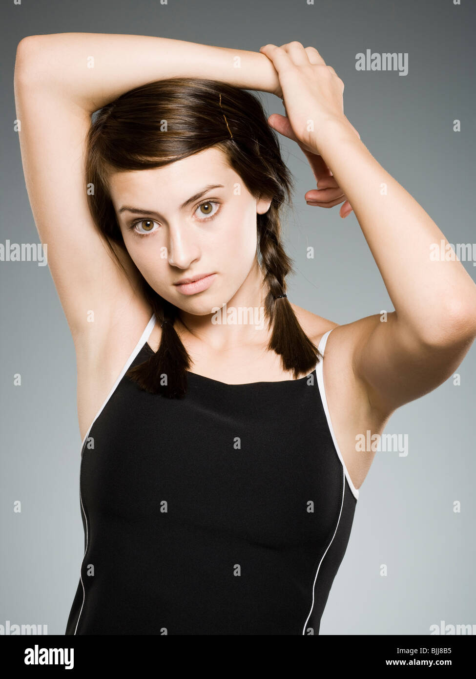 Teenage girl stretching arms Stock Photo - Alamy