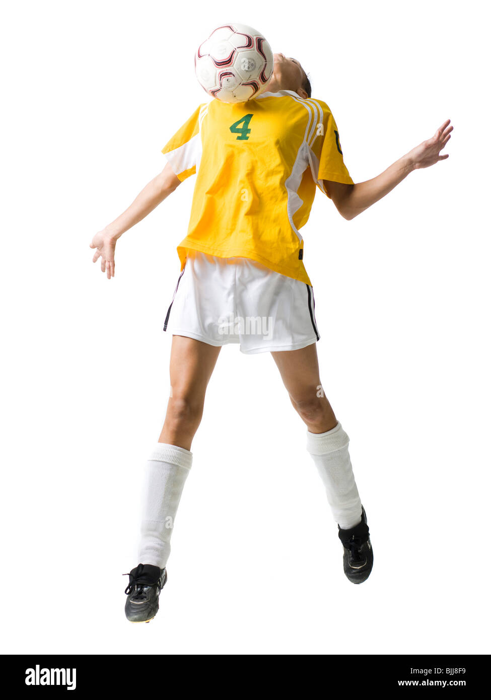 Teenage girl heading soccer ball Stock Photo - Alamy