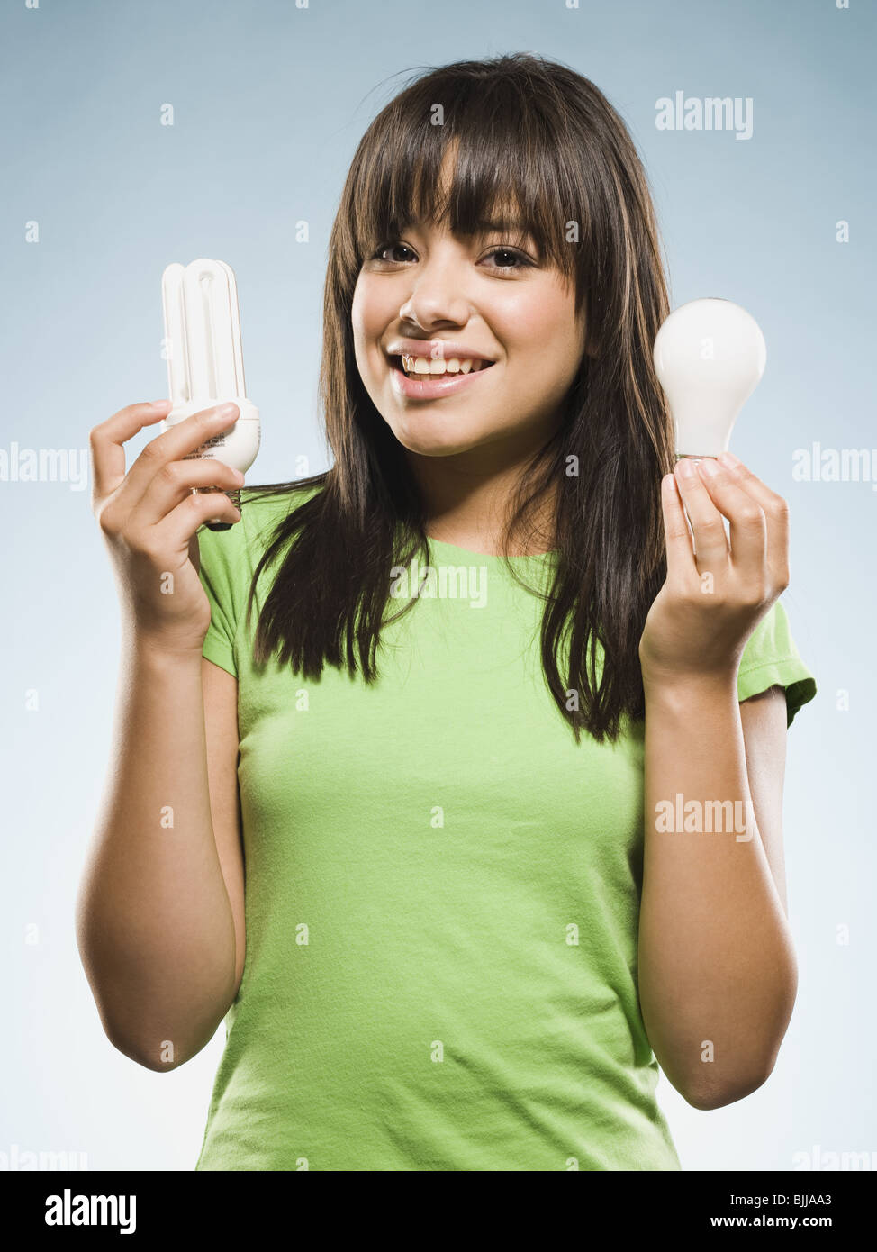 Woman with fluorescent and incandescent light bulbs Stock Photo - Alamy