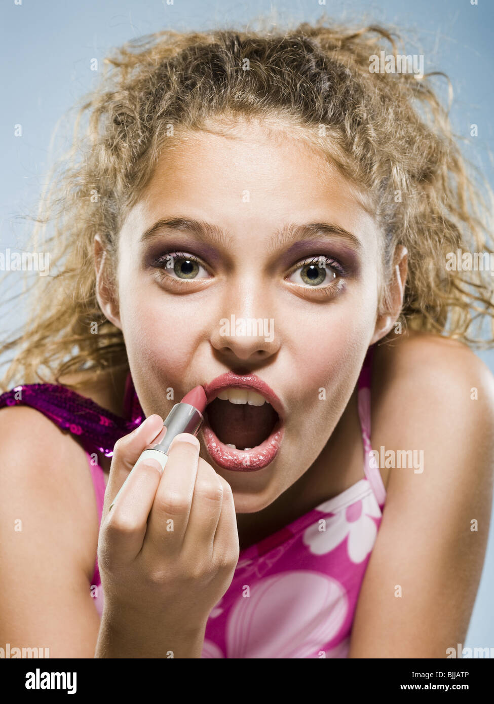 Closeup of girl applying lipstick Stock Photo - Alamy