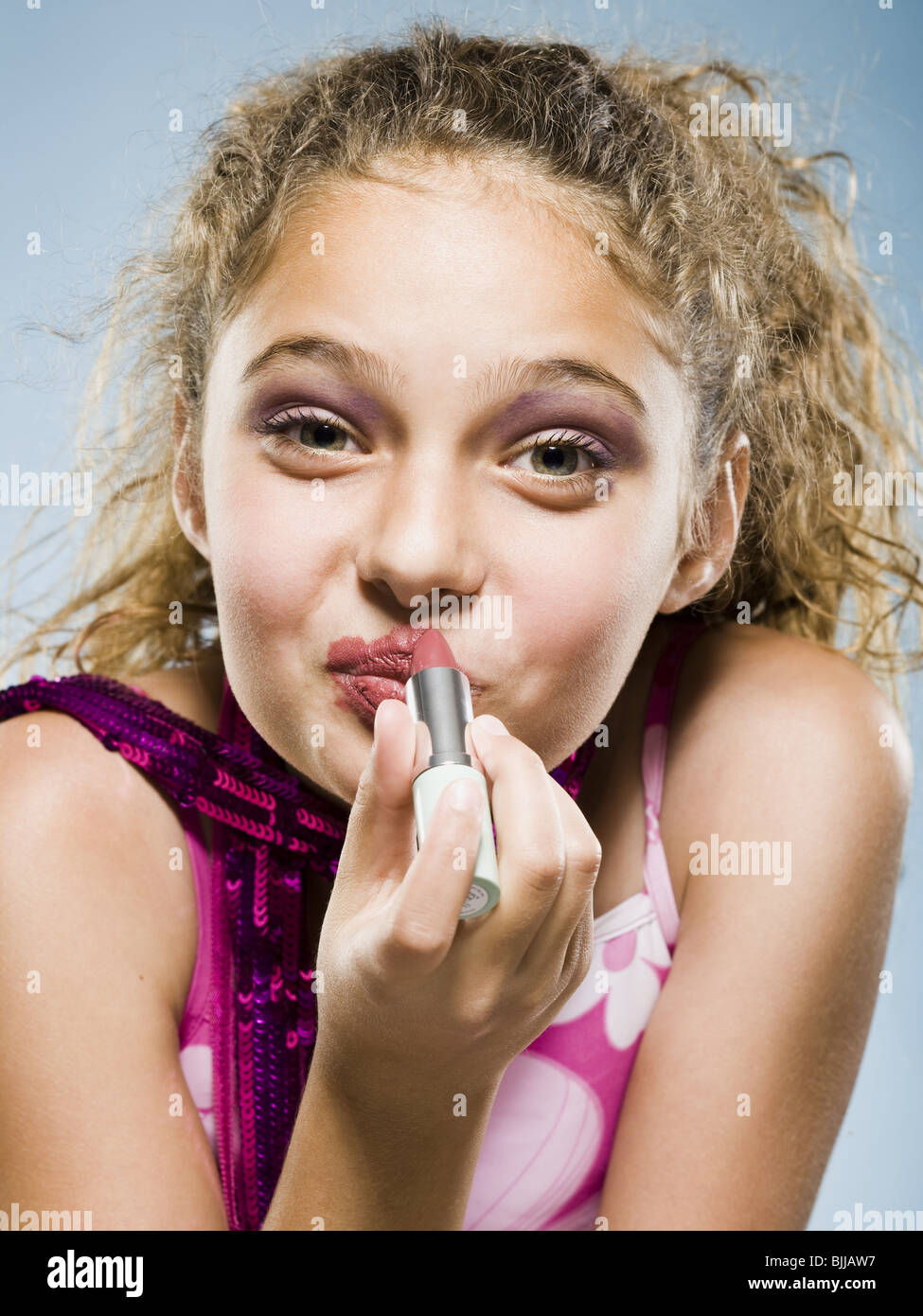 Closeup of girl applying lipstick Stock Photo - Alamy