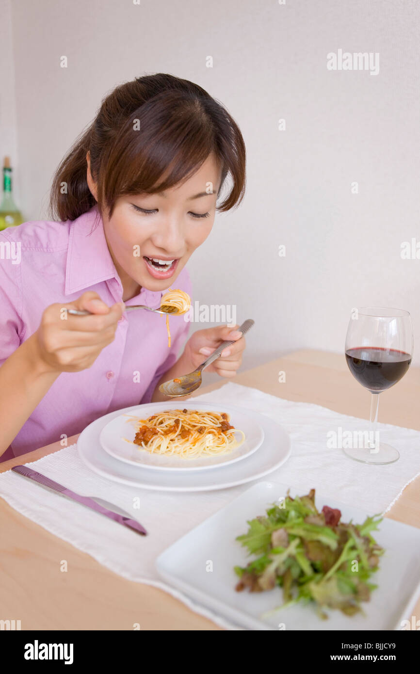 Young woman eating spaghetti Stock Photo - Alamy