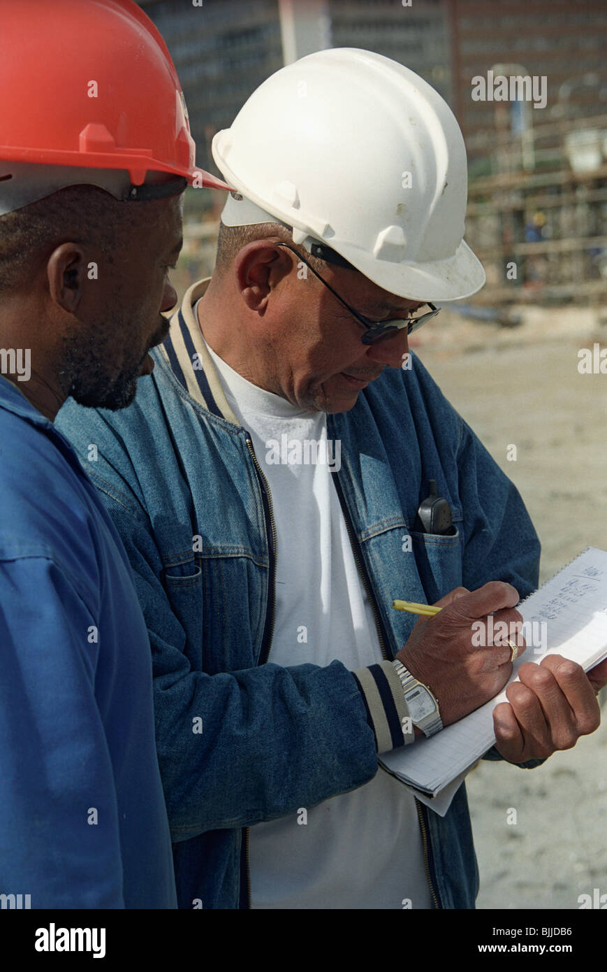 Construction worker check list hat hi-res stock photography and images ...