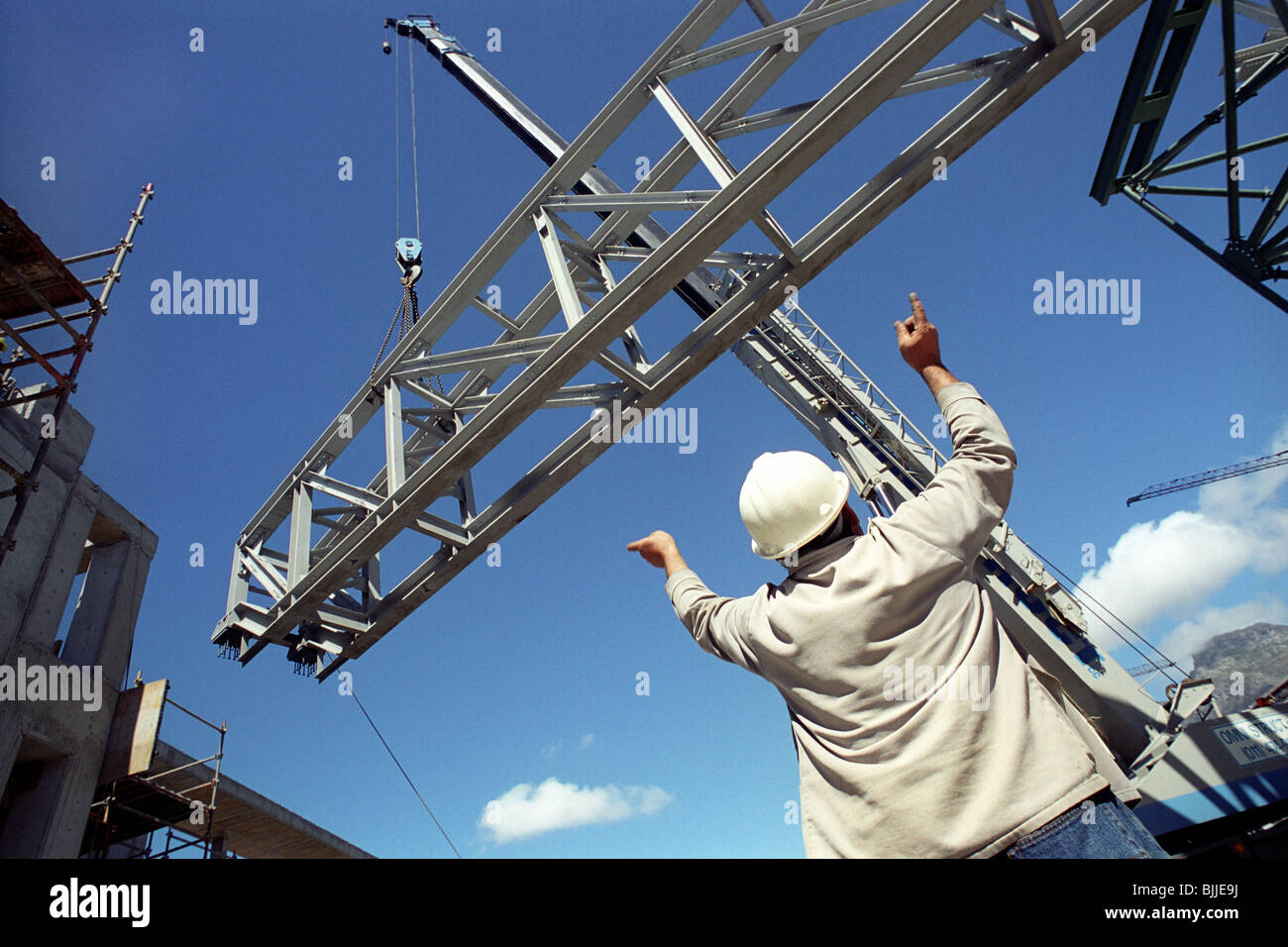 Engineer directing crane operator Stock Photo - Alamy
