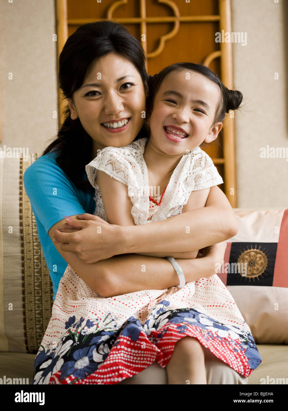 Mother and daughter embracing and smiling Stock Photo - Alamy