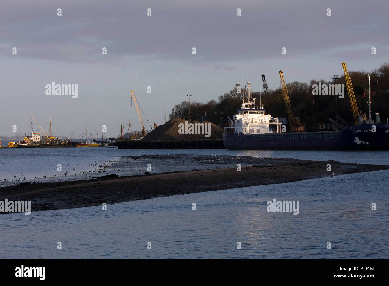 A small cargo ship in the tiny port of Mistley Quay at evening Stock ...