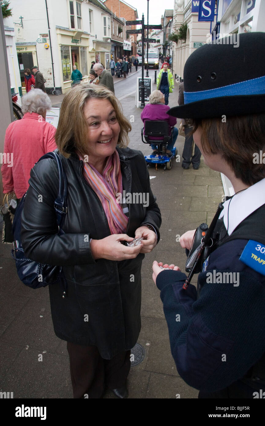 A middle aged lady discusses purse chains with a female Police ...
